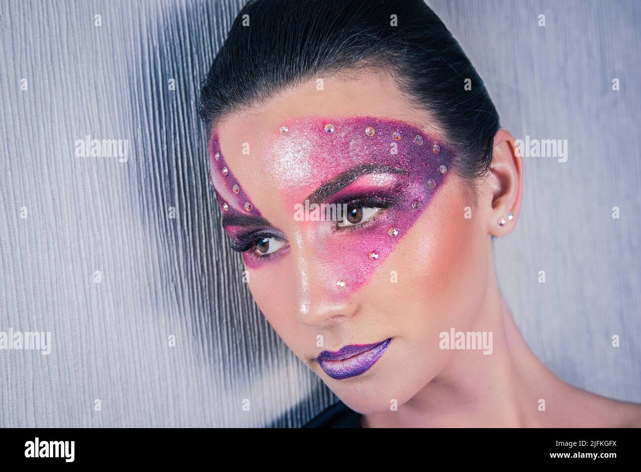 Beautiful Caucasian woman closeup with purple face painting and ...
