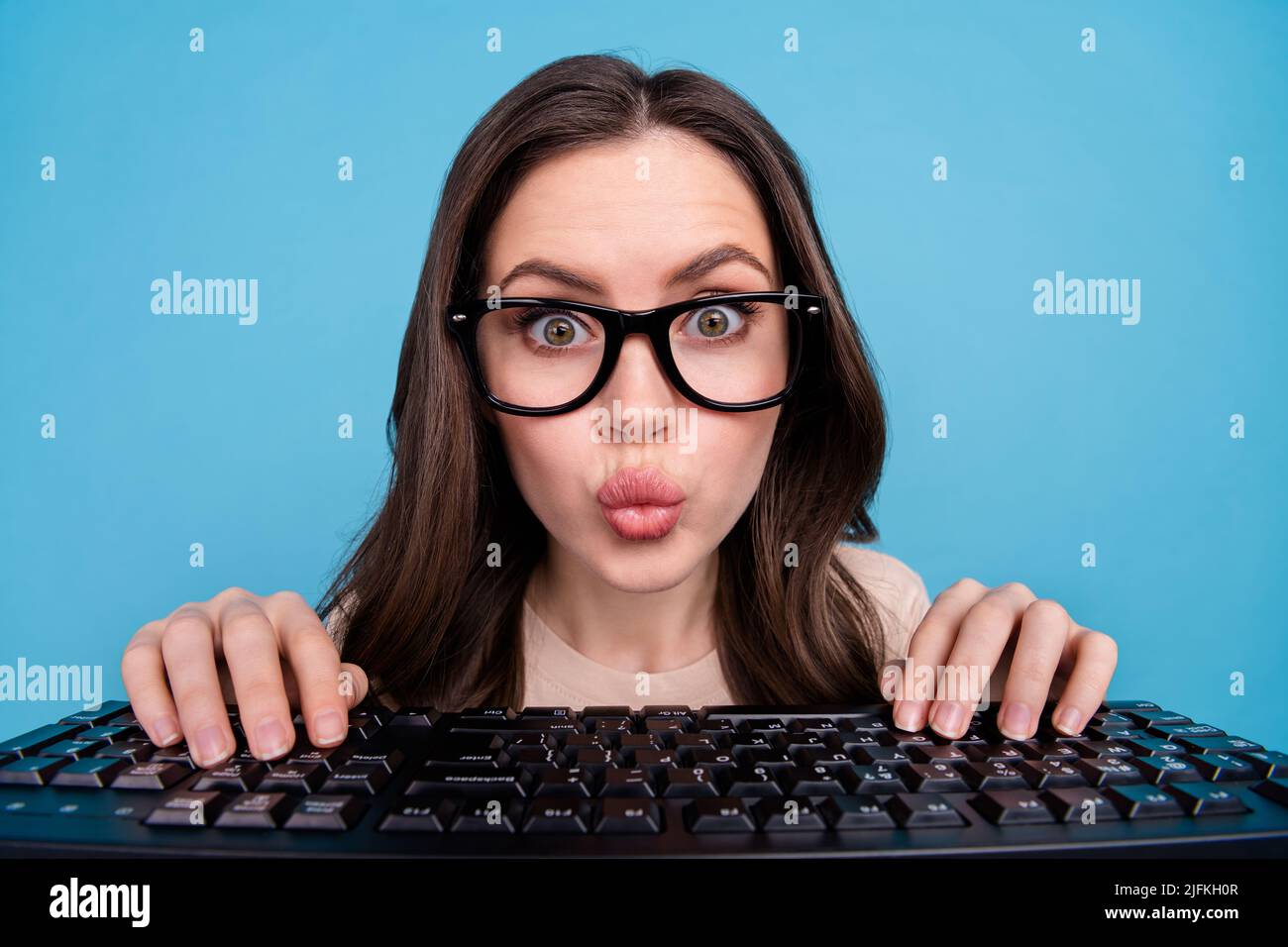 Close-up portrait of funny focused female working on new project typing ...