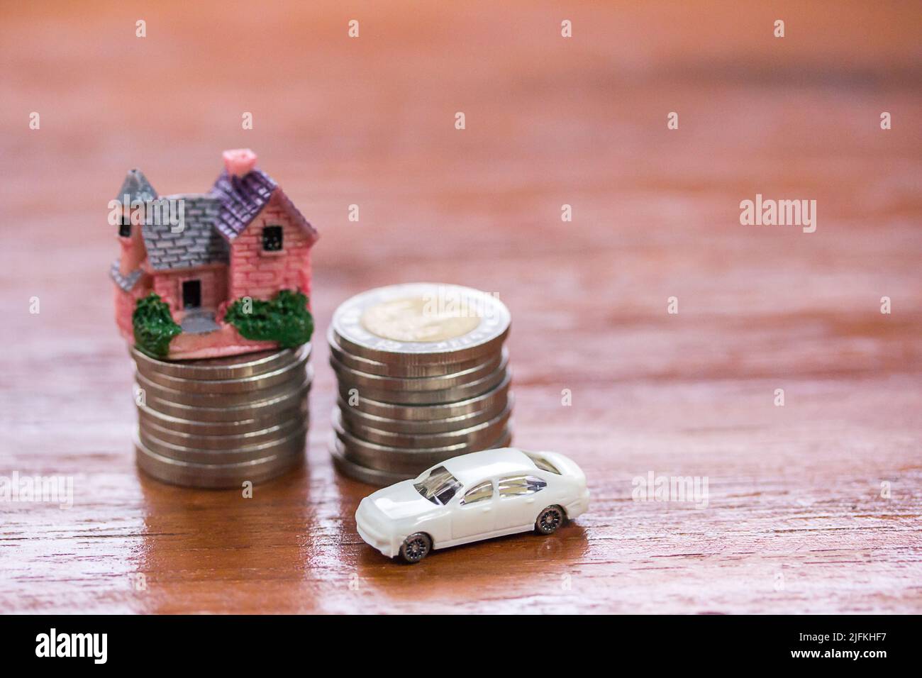Toy car and coins stacks on wood table background. Office desk with ...