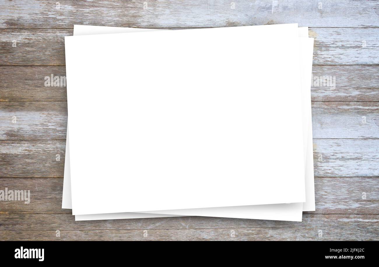 White paper or notepad on brown wood table background.using wallpaper ...