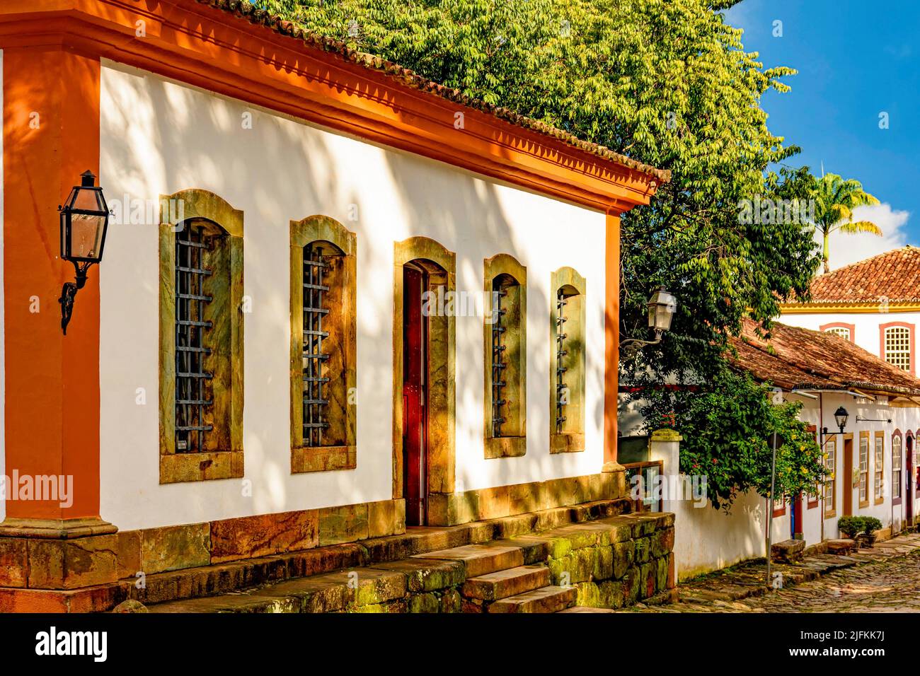 Stone paving street and colorful colonial-style houses in the afternoon ...