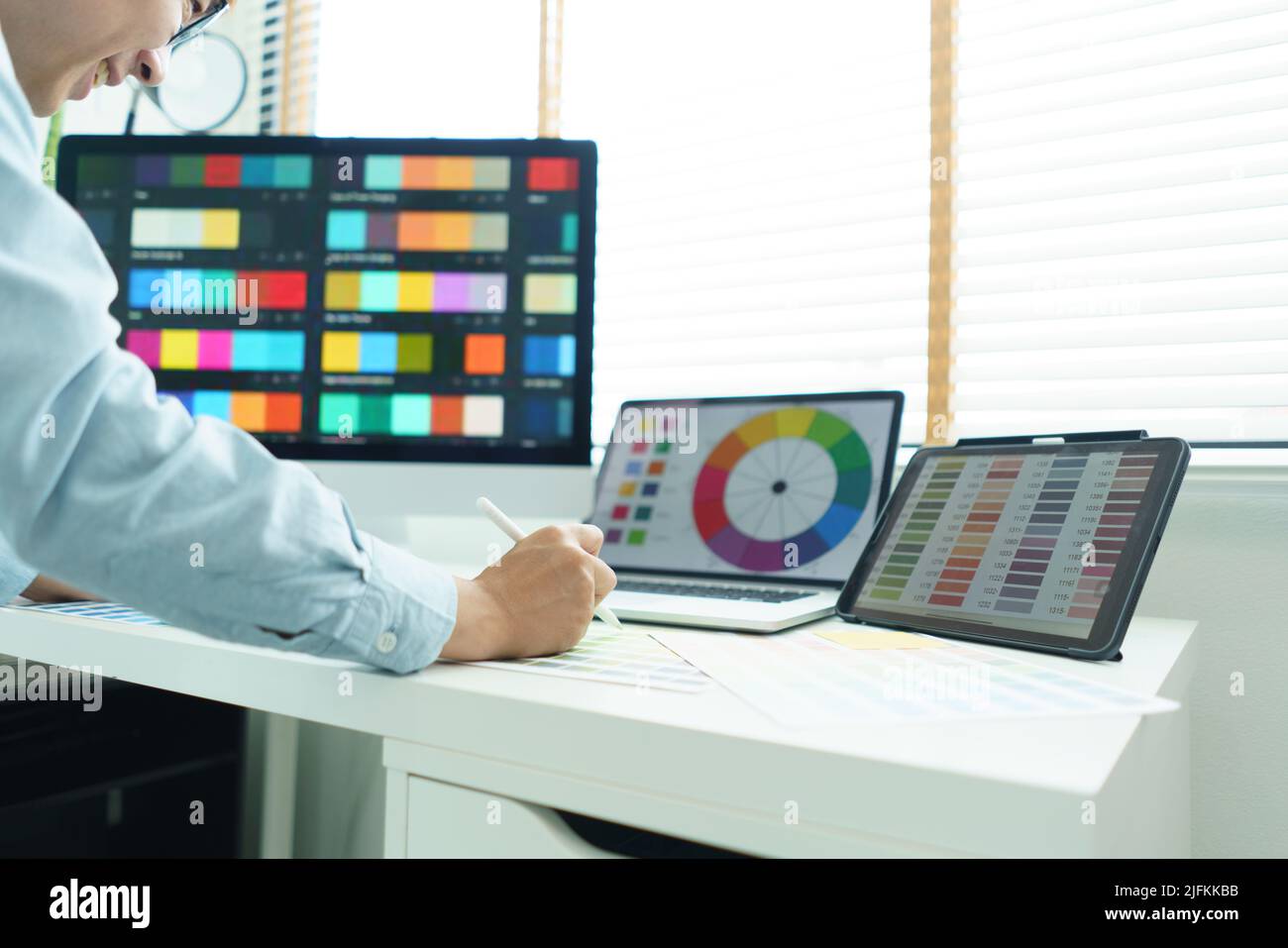 Creativity concept, Male graphic designer choosing color swatch samples ...