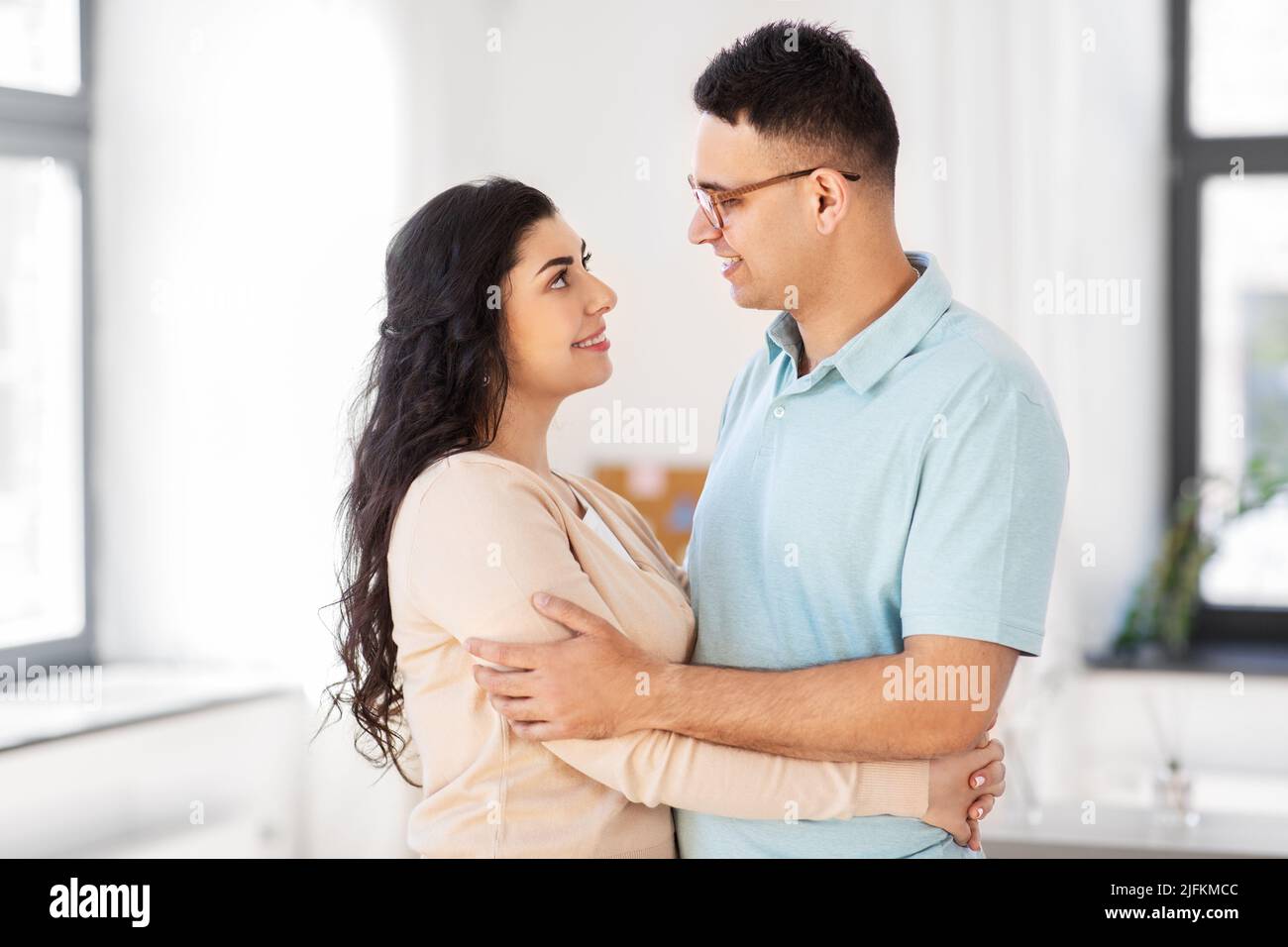 Young happy couple talking hugging hi-res stock photography and images ...