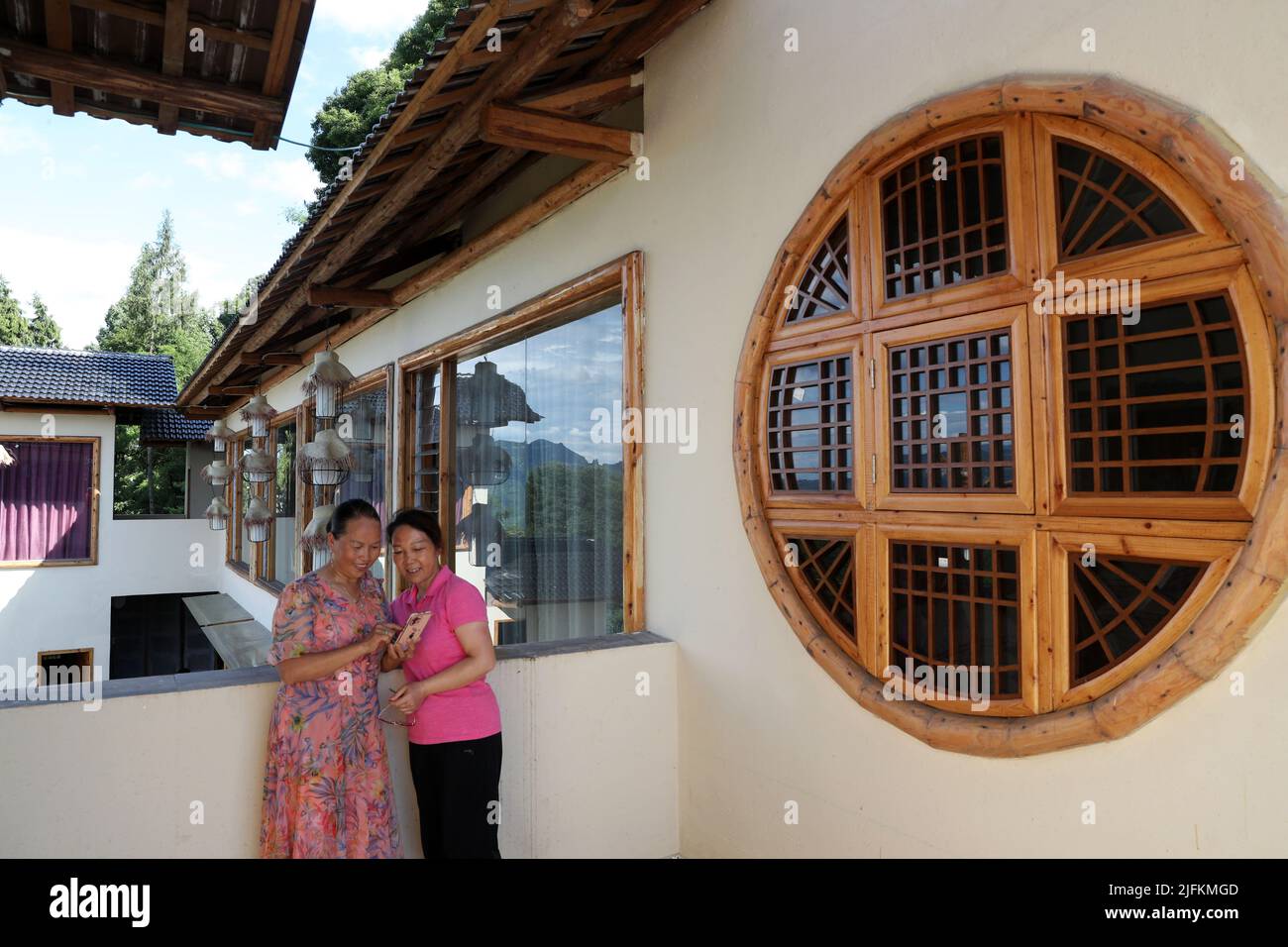 CHONGQING, CHINA - JULY 3, 2022 - Tourists take a rest in a b&B village ...