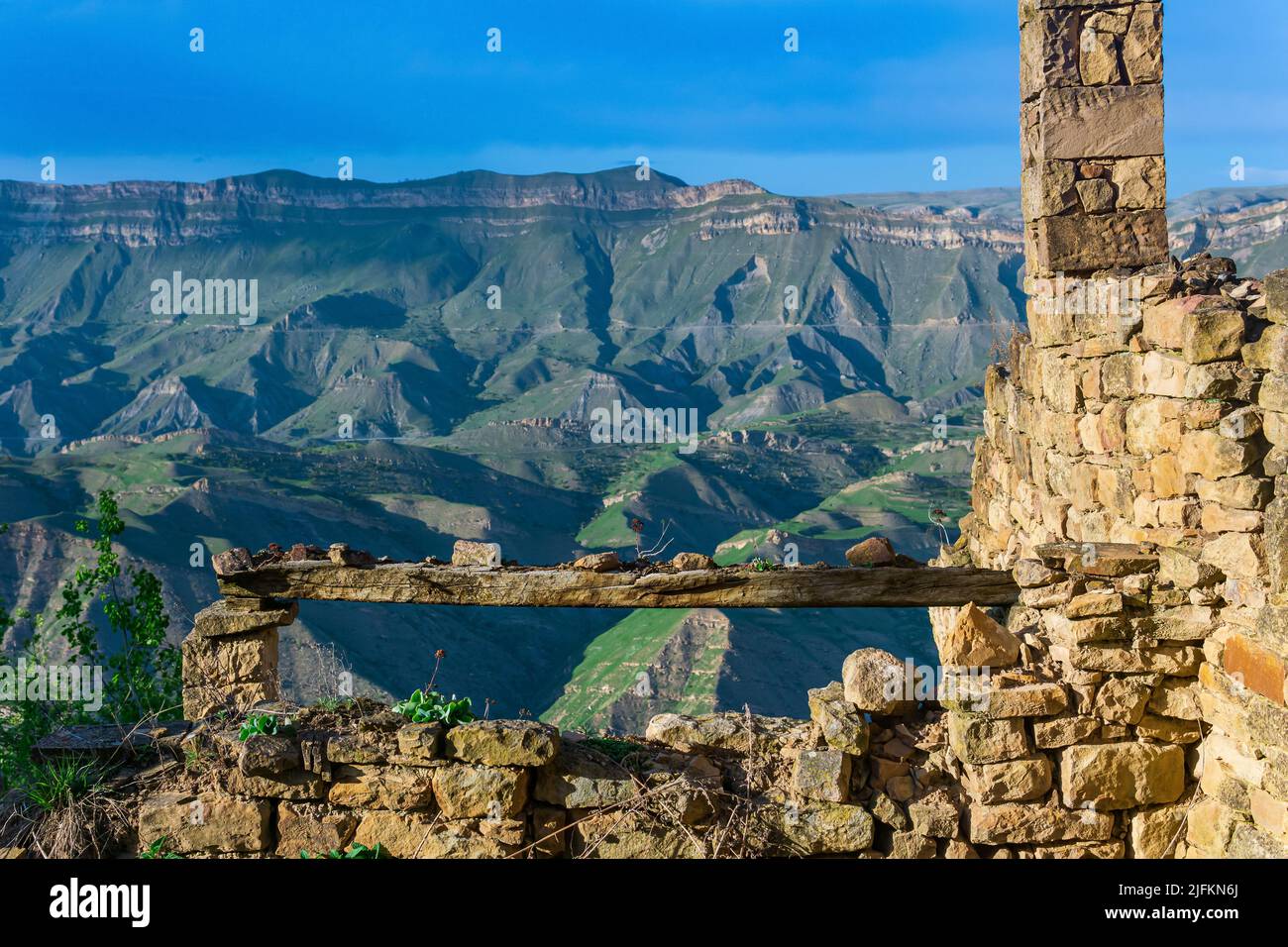 bench over an abyss in the ruins of the historic mountain village of ...