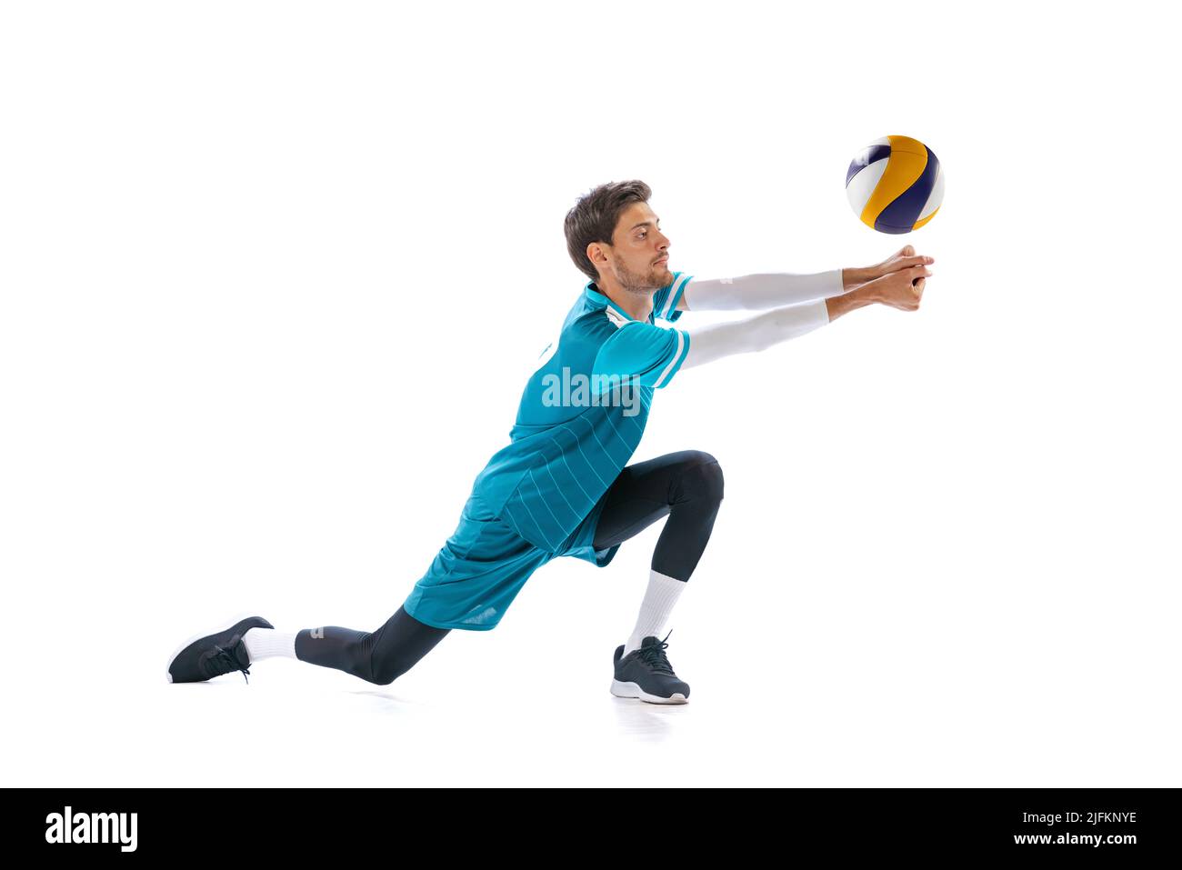Portrait of young concentrated man, volleyball player in motion ...