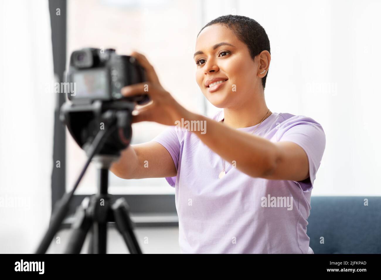 female video blogger adjusting camera at home Stock Photo - Alamy