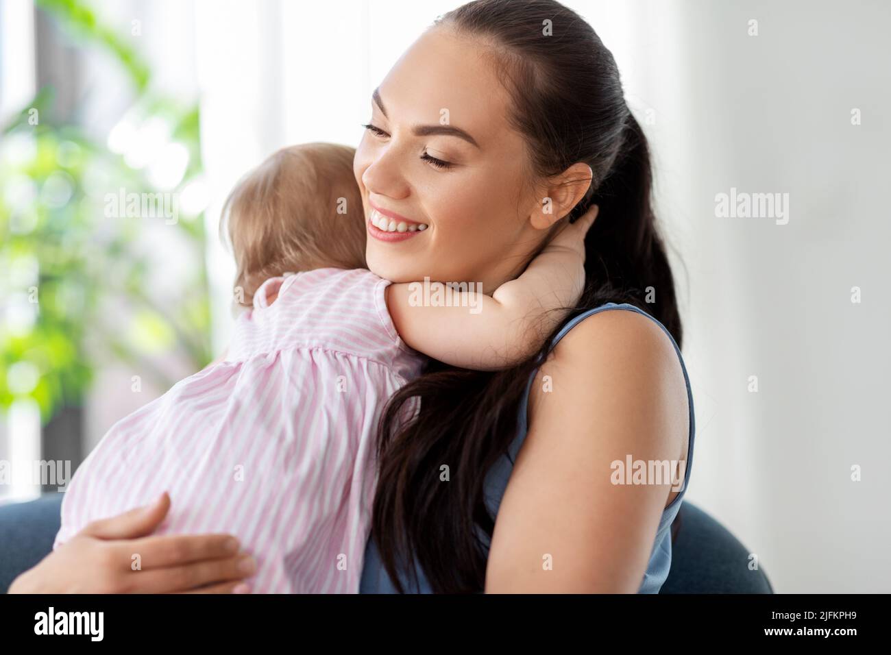 happy mother hugging little baby daughter at home Stock Photo - Alamy