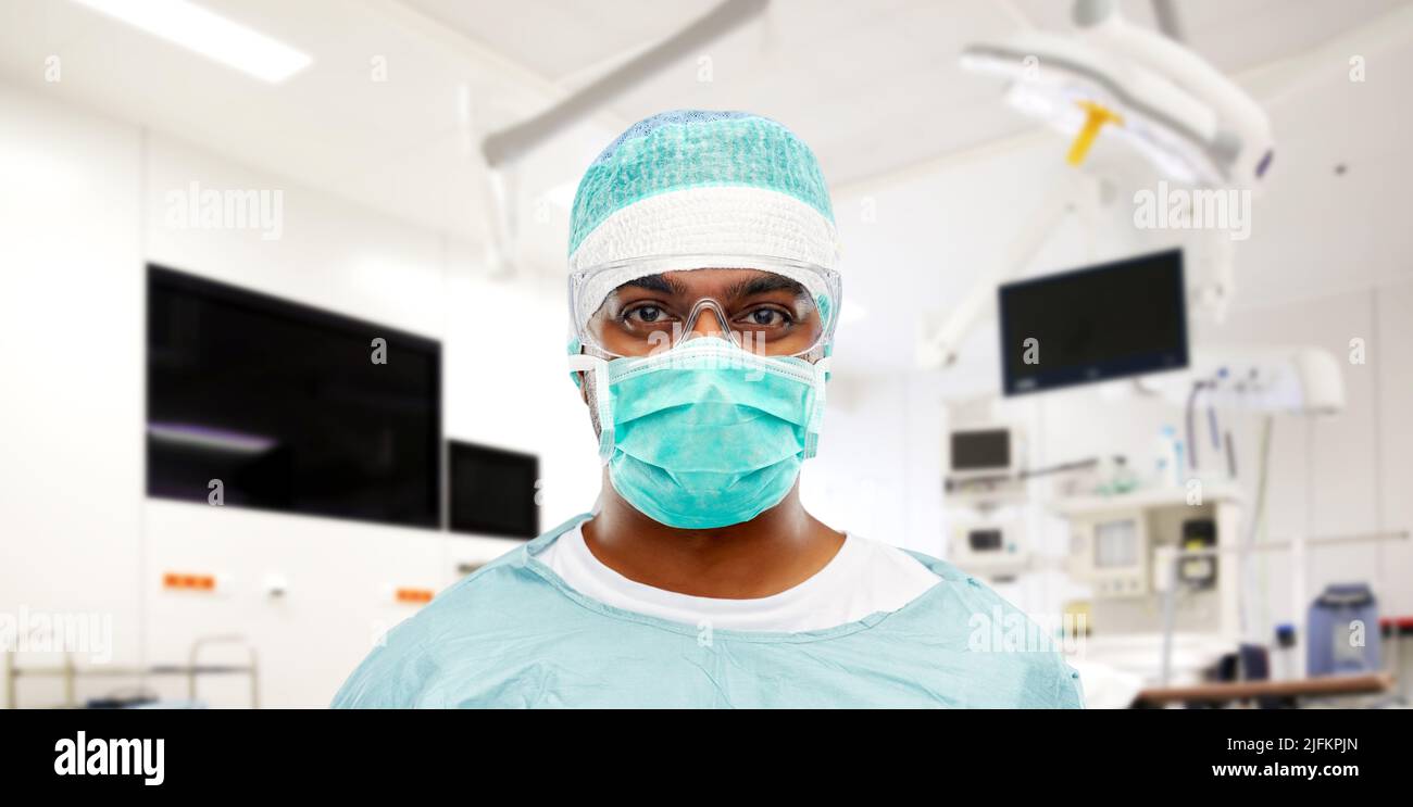 indian male surgeon in mask over operating room Stock Photo - Alamy