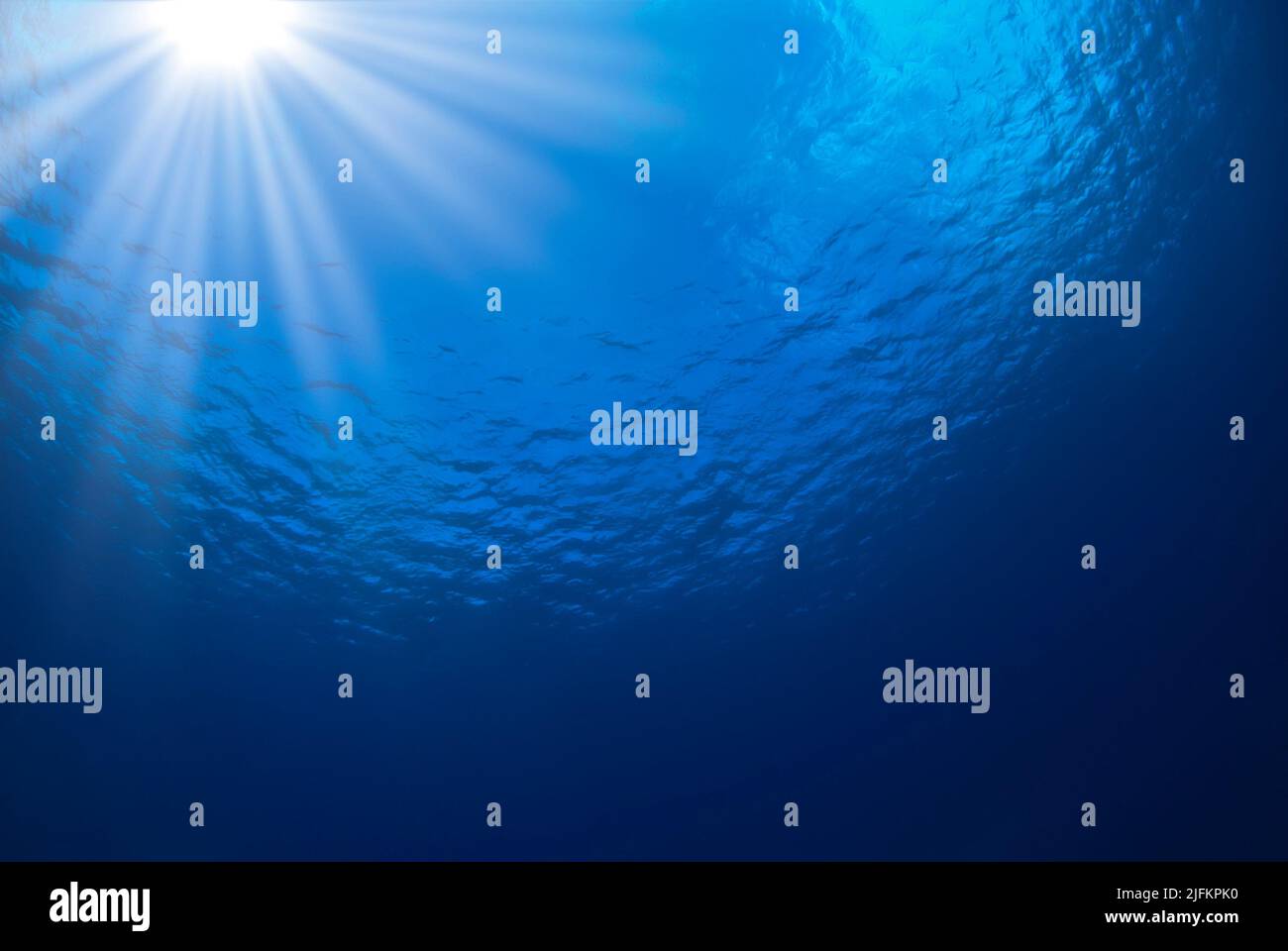 Ocean blue background with rays of sun Stock Photo - Alamy