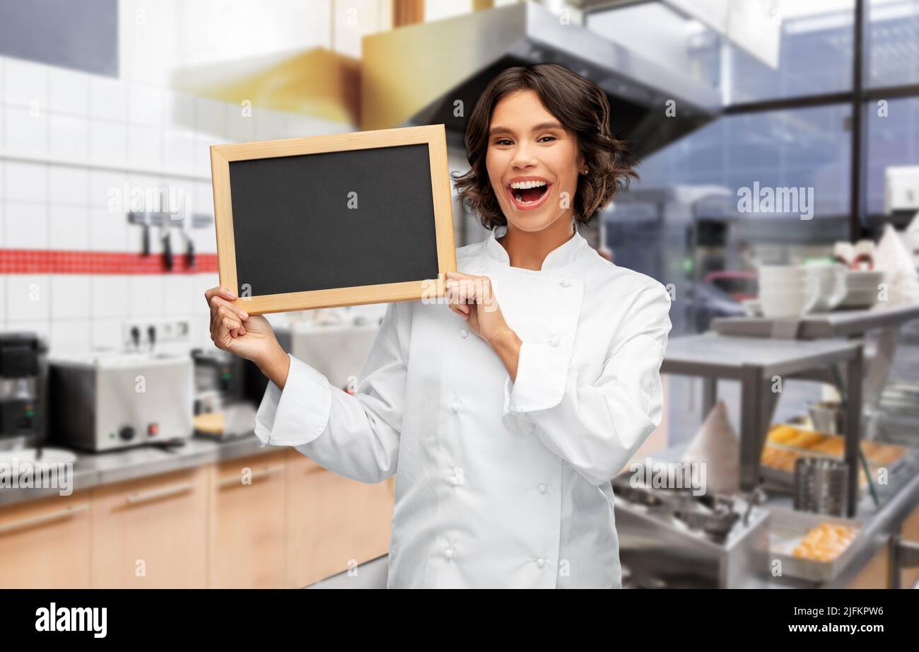 happy female chef holding chalkboard at kebab shop Stock Photo - Alamy