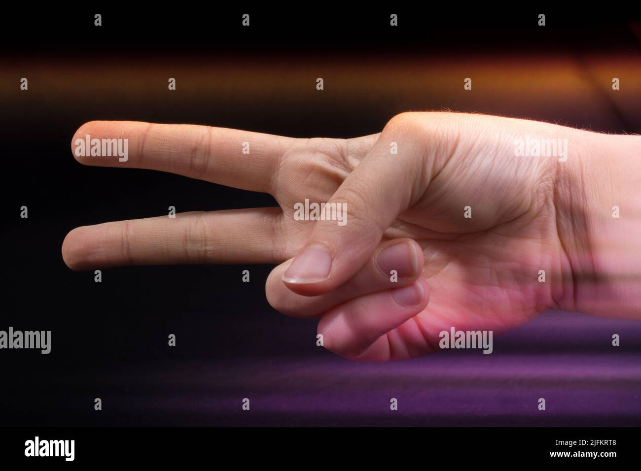 The sign of victory and peace in black background Stock Photo - Alamy