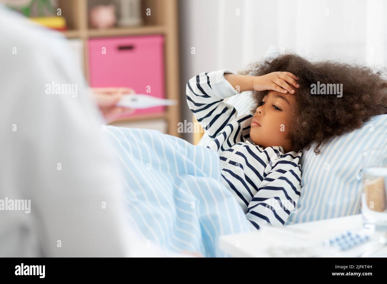 doctor measuring sick girl's temperature Stock Photo - Alamy