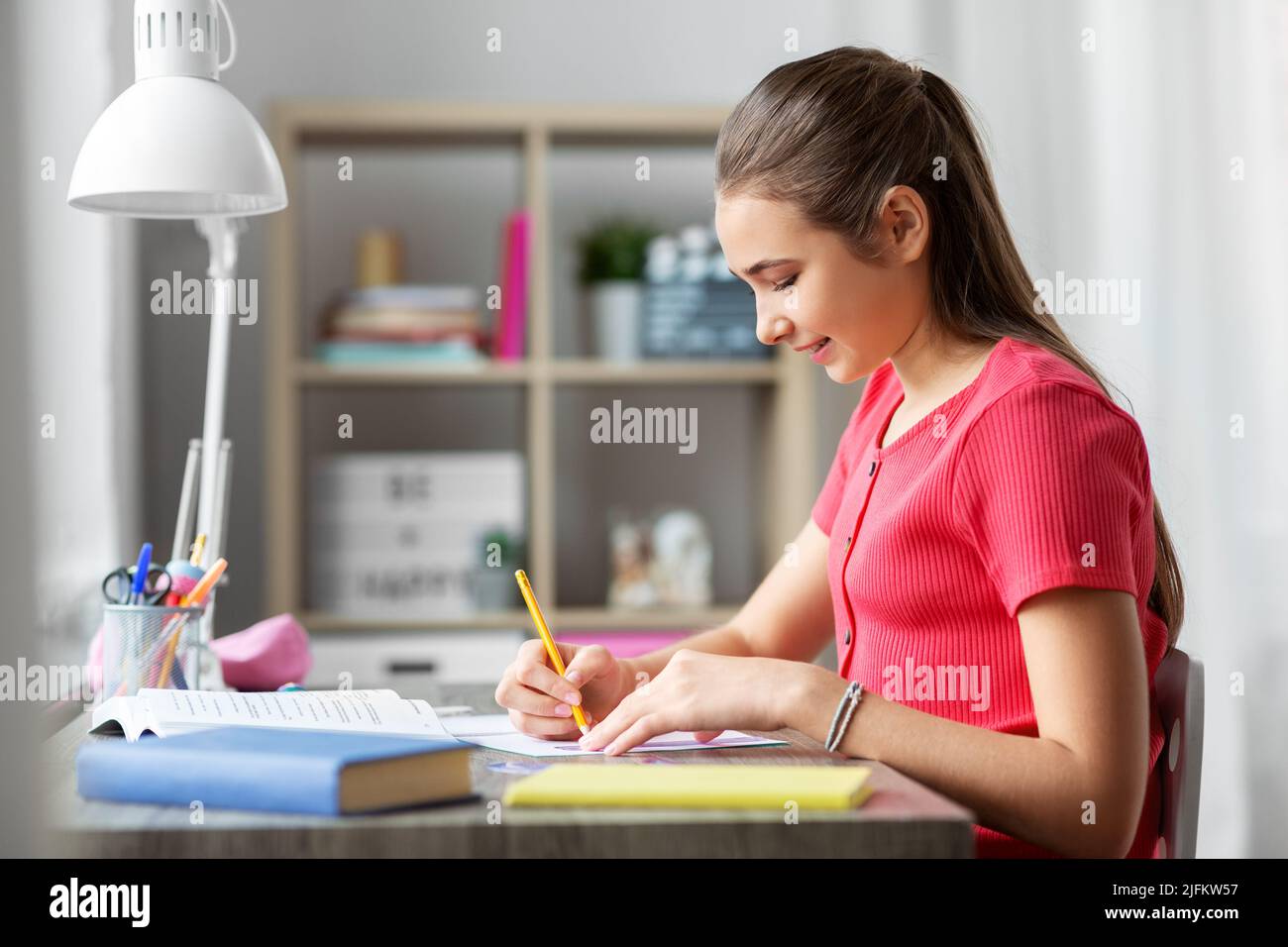student girl with ruler drawing line in notebook Stock Photo - Alamy