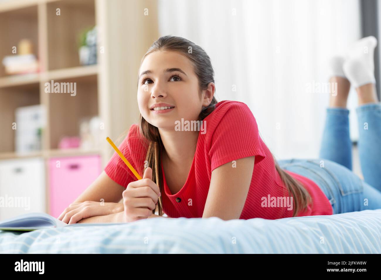 teenage girl writing to diary at home Stock Photo - Alamy