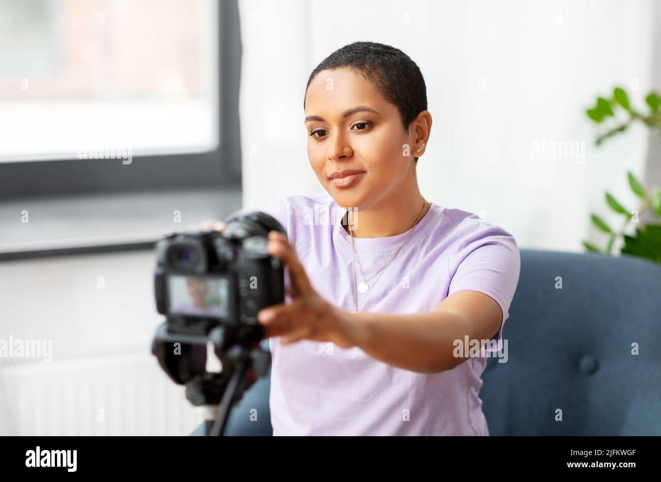 female video blogger adjusting camera at home Stock Photo - Alamy