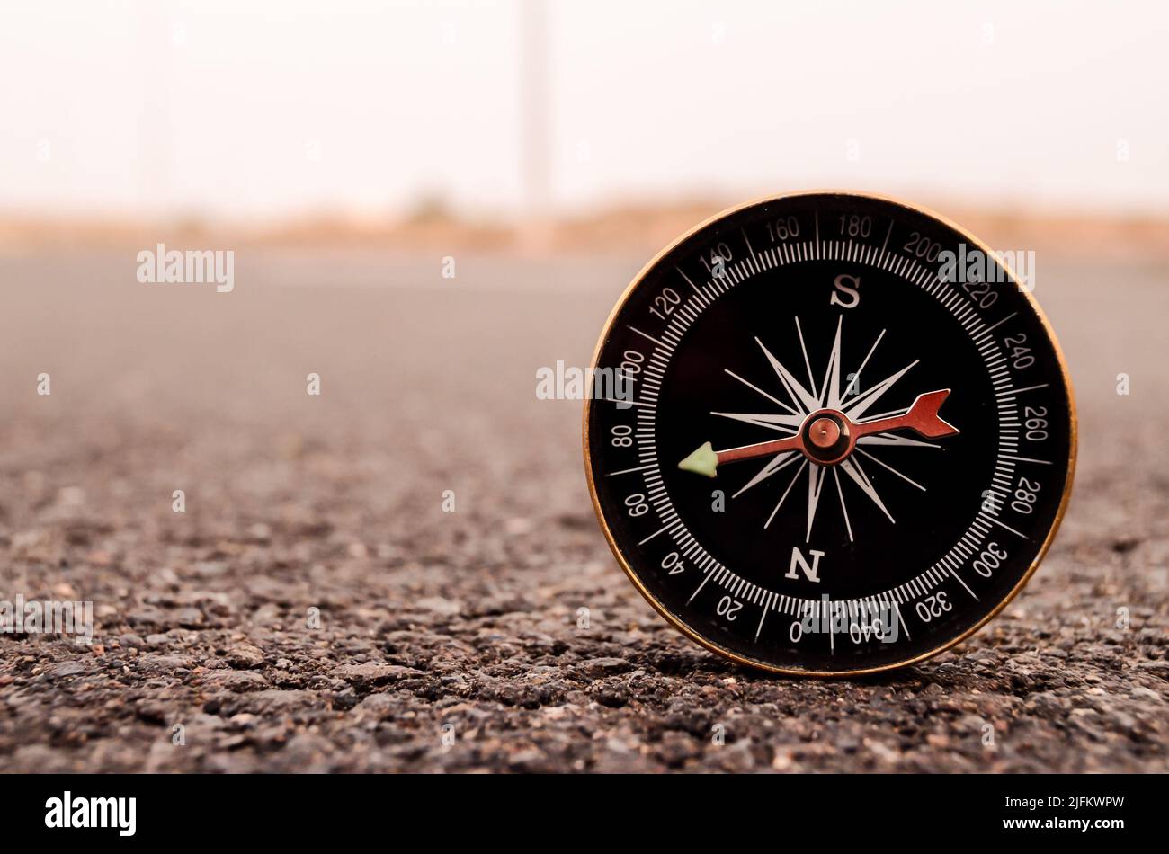 Travel Concept Compass on the Asphlat Road Stock Photo - Alamy
