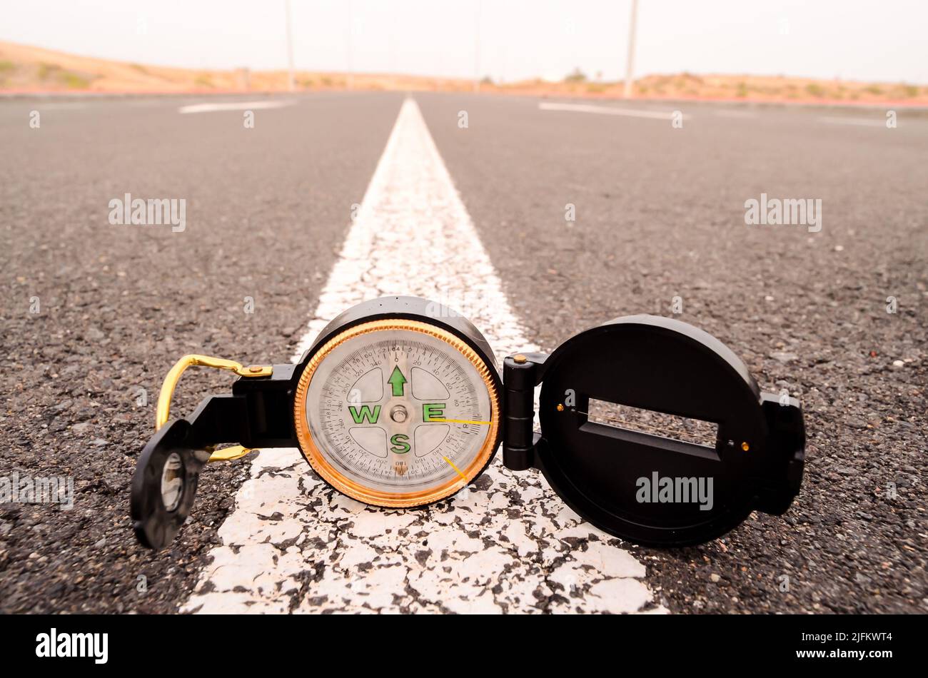 Travel Concept Compass on the Asphlat Road Stock Photo - Alamy
