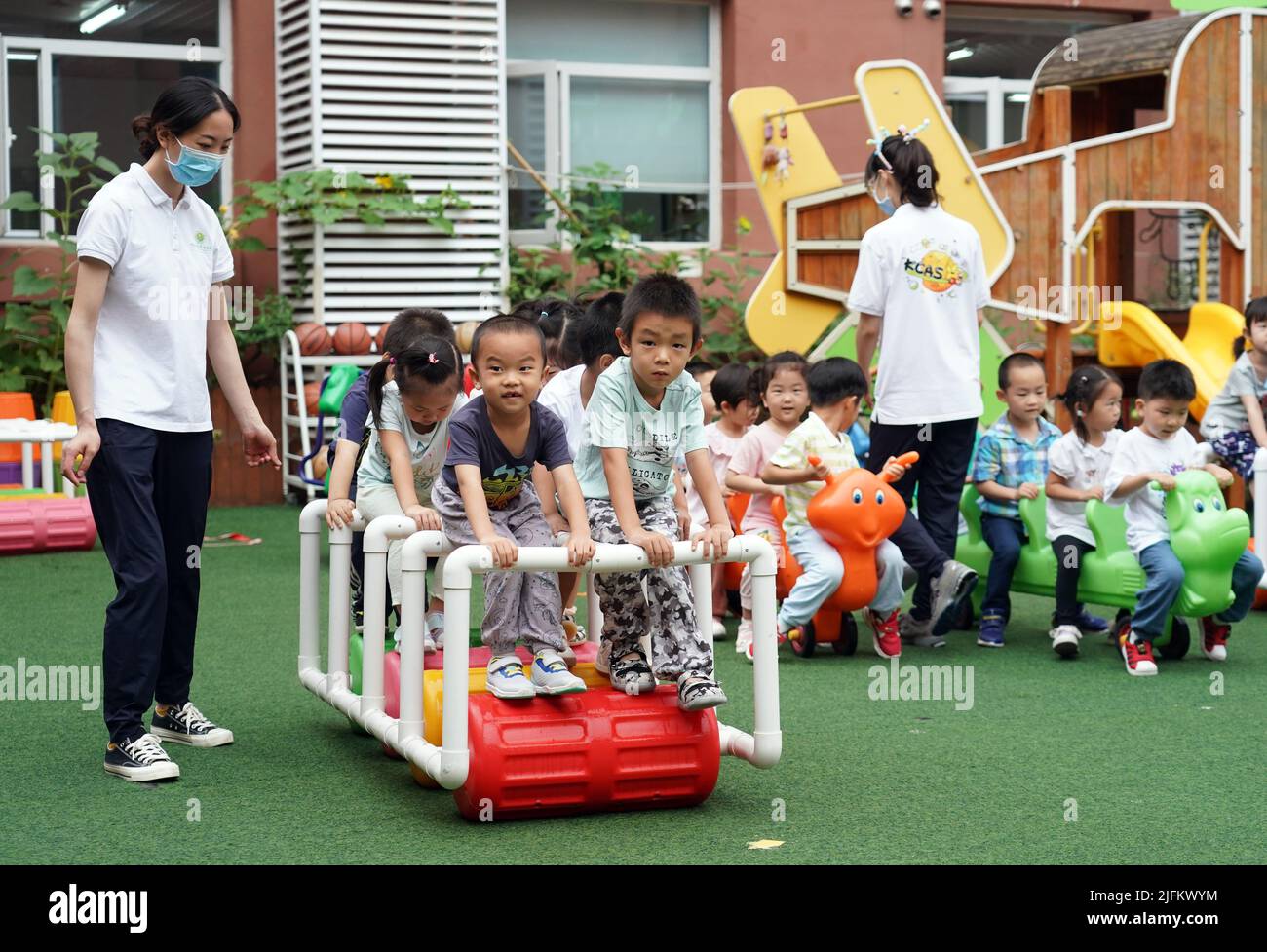 Beijing, China. 4th July, 2022. Children play outdoor as a kindergarten ...