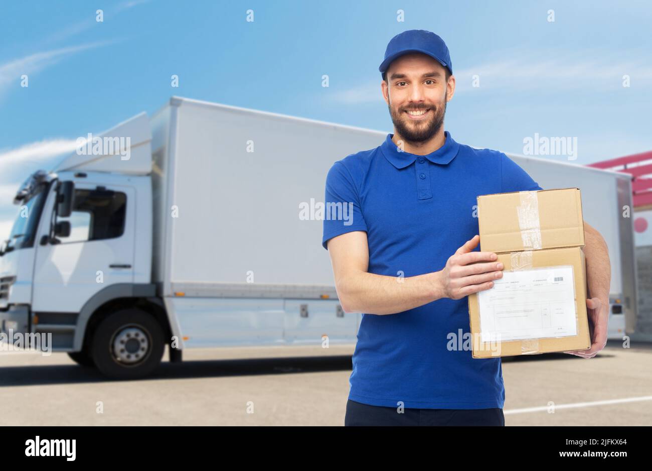 happy delivery man with parcel boxes Stock Photo - Alamy