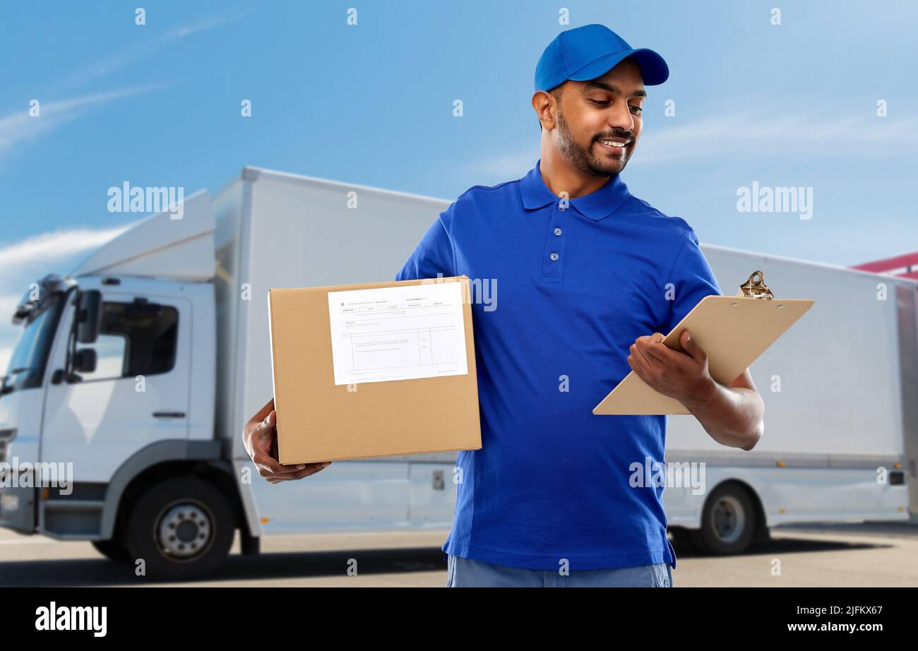 indian delivery man with parcel box and clipboard Stock Photo - Alamy