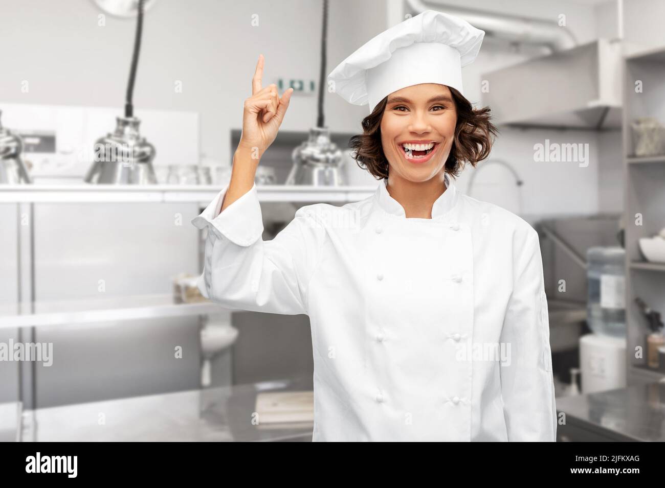 female chef pointing finger up over restaurant Stock Photo - Alamy