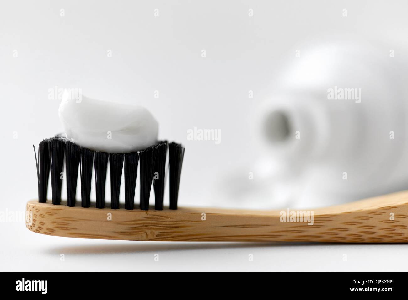 natural wooden toothbrush with toothpaste on it Stock Photo - Alamy