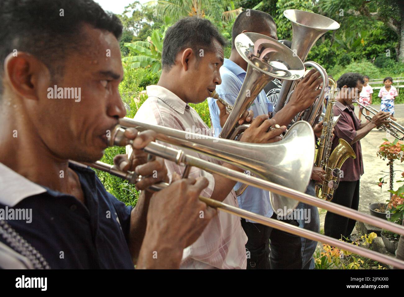 Villagers playing brass instruments during a rural orchestra ...