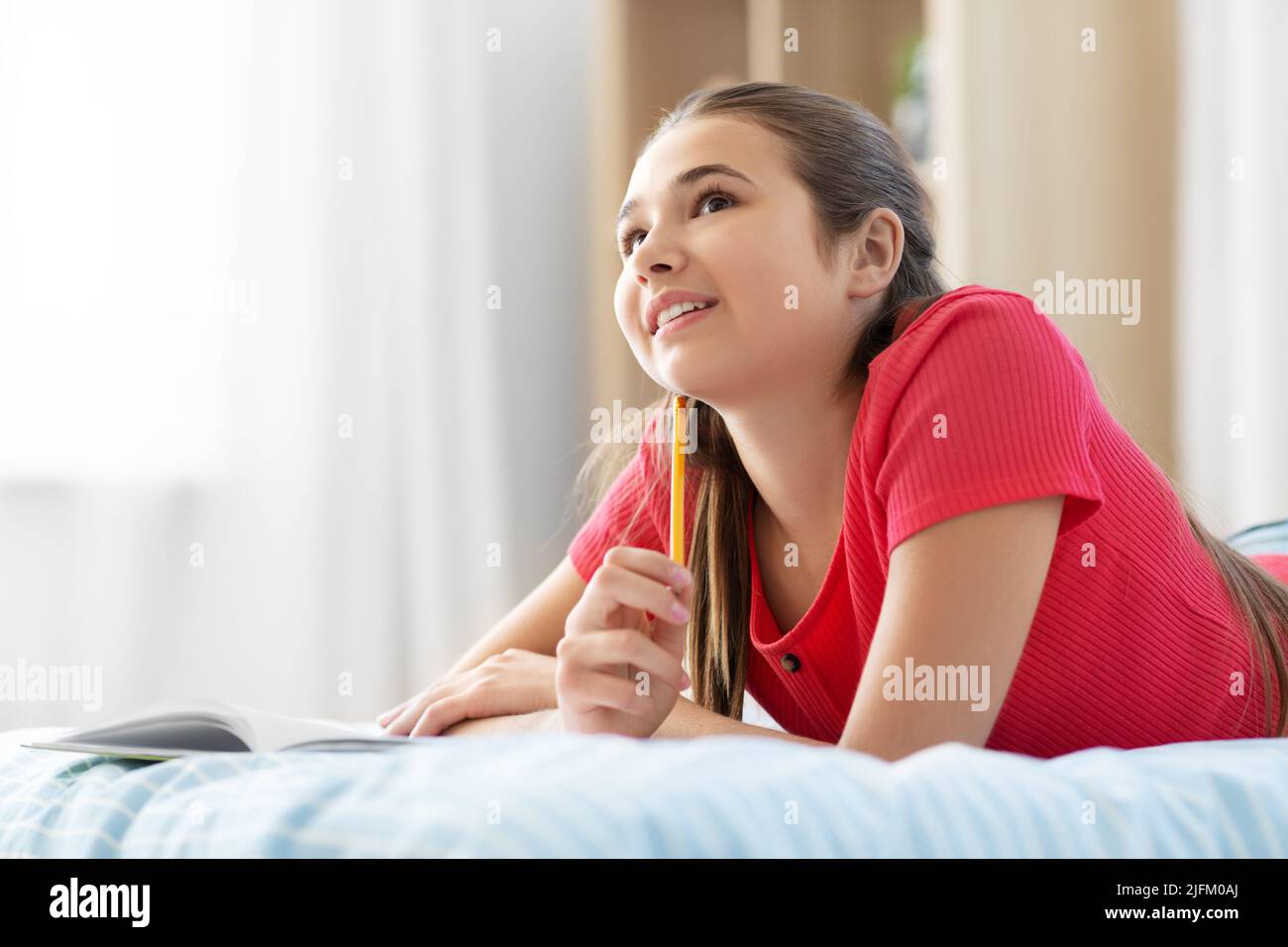 teenage girl writing to diary at home Stock Photo - Alamy