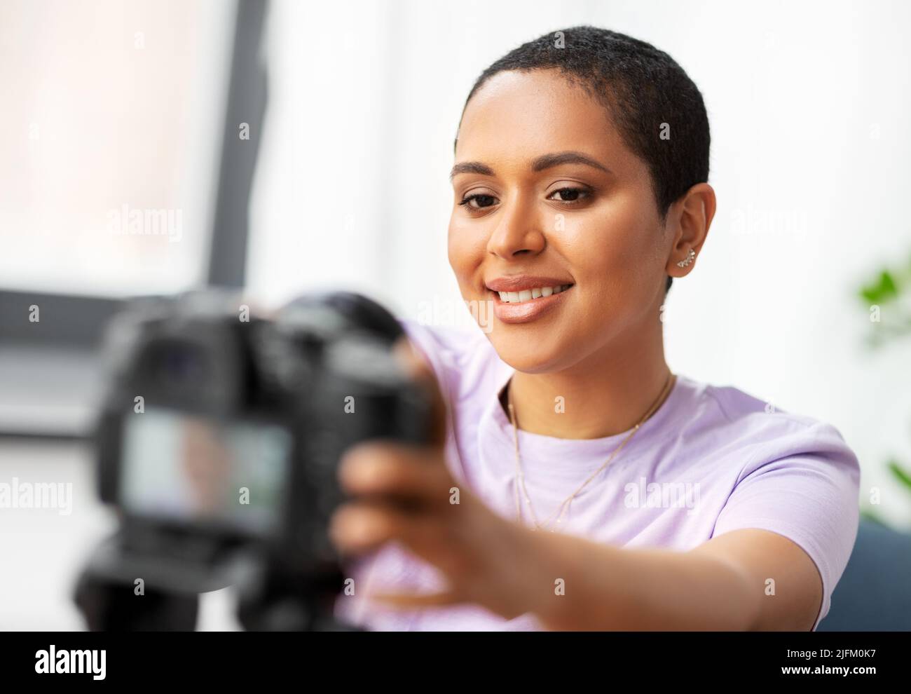 female video blogger adjusting camera at home Stock Photo - Alamy