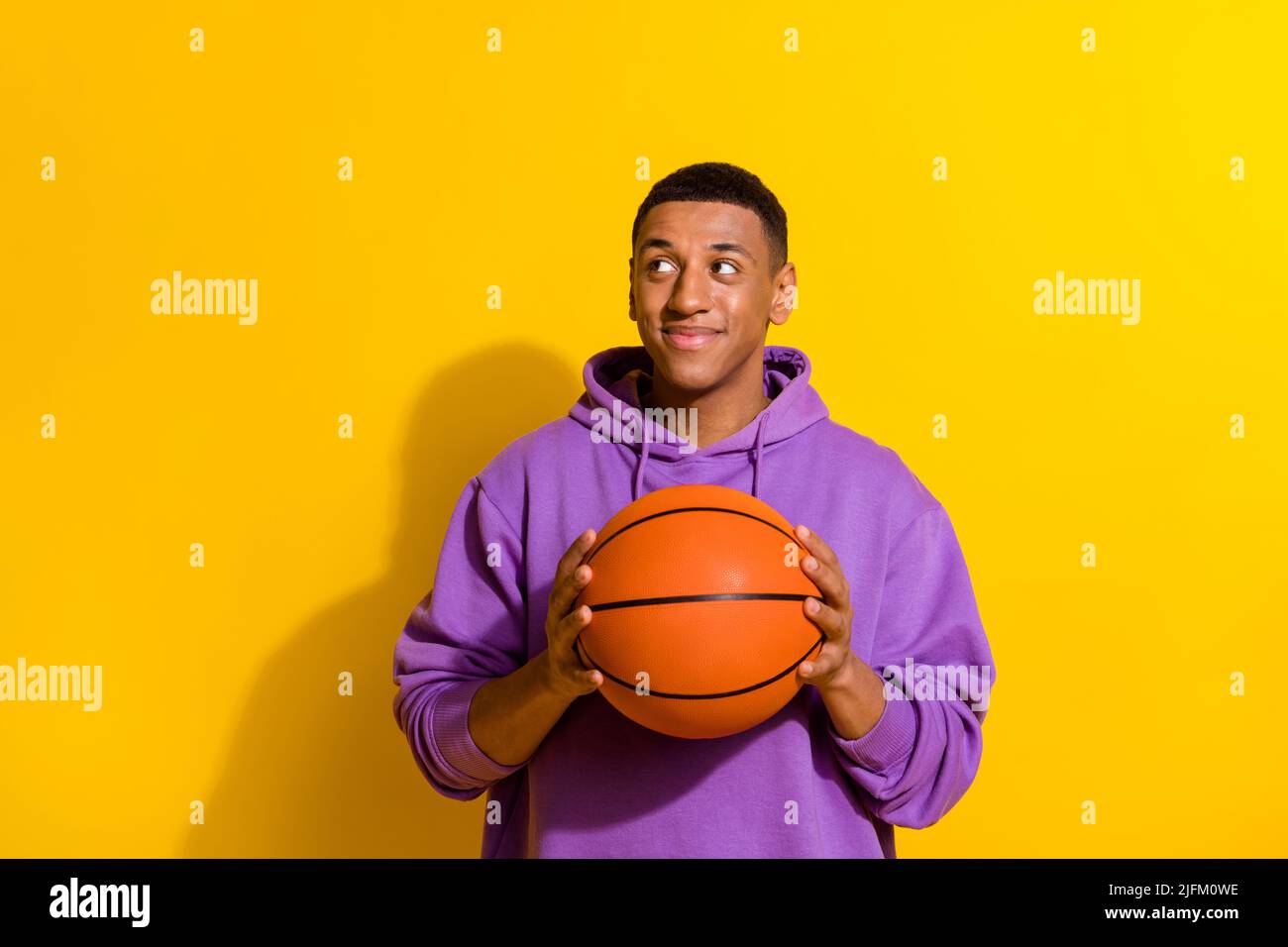 Portrait of attractive professional sportive guy playing basketball ...