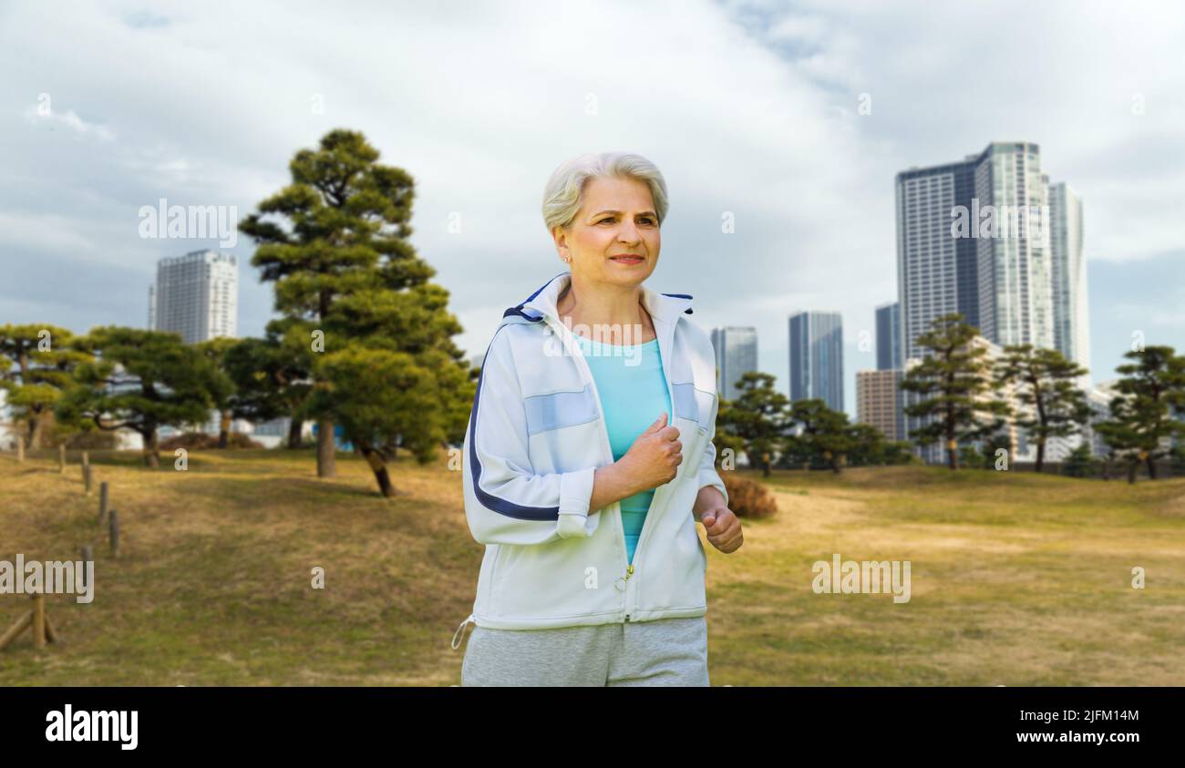 senior woman running along summer park Stock Photo - Alamy