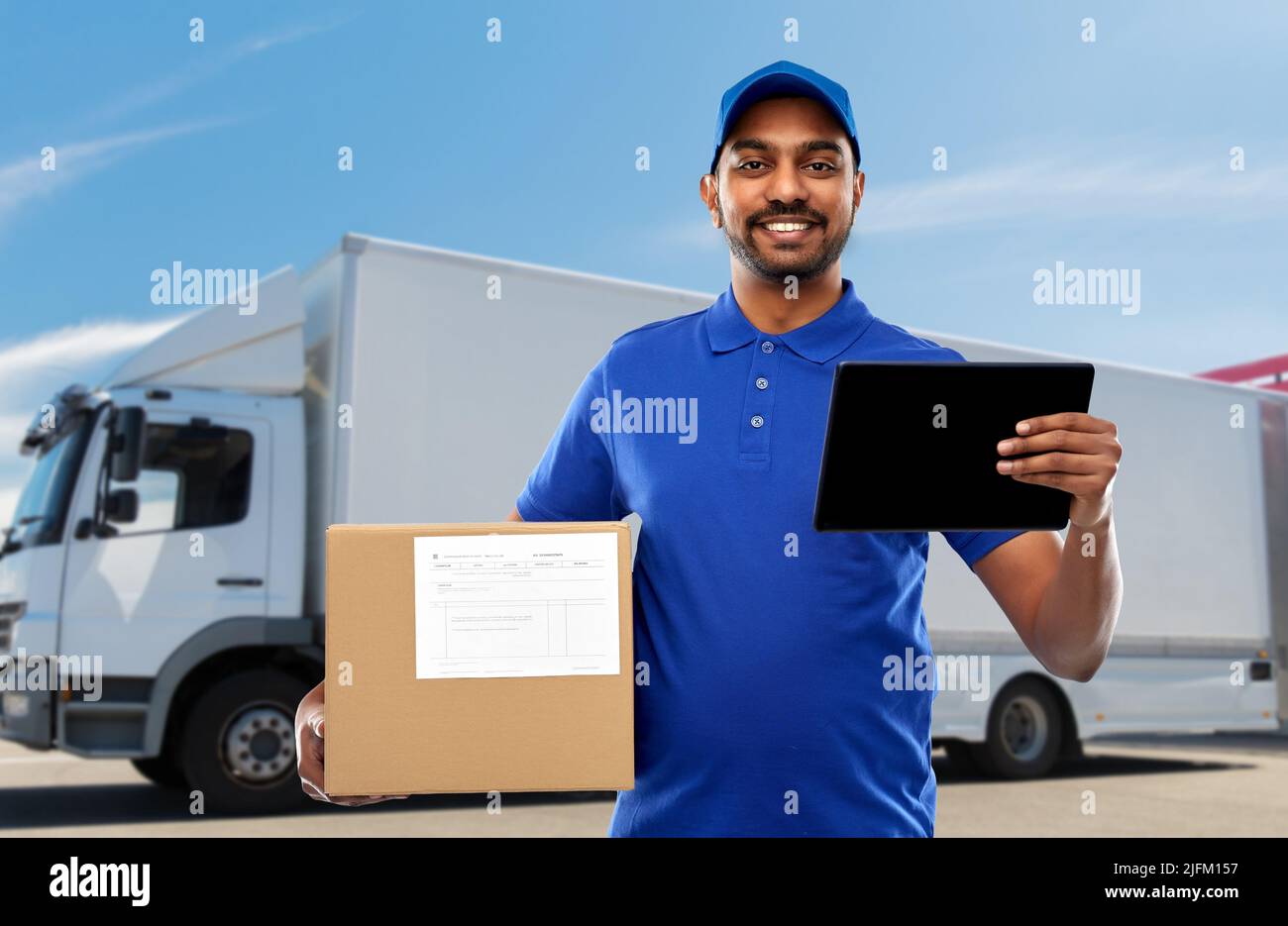 indian delivery man with tablet pc and parcel box Stock Photo - Alamy