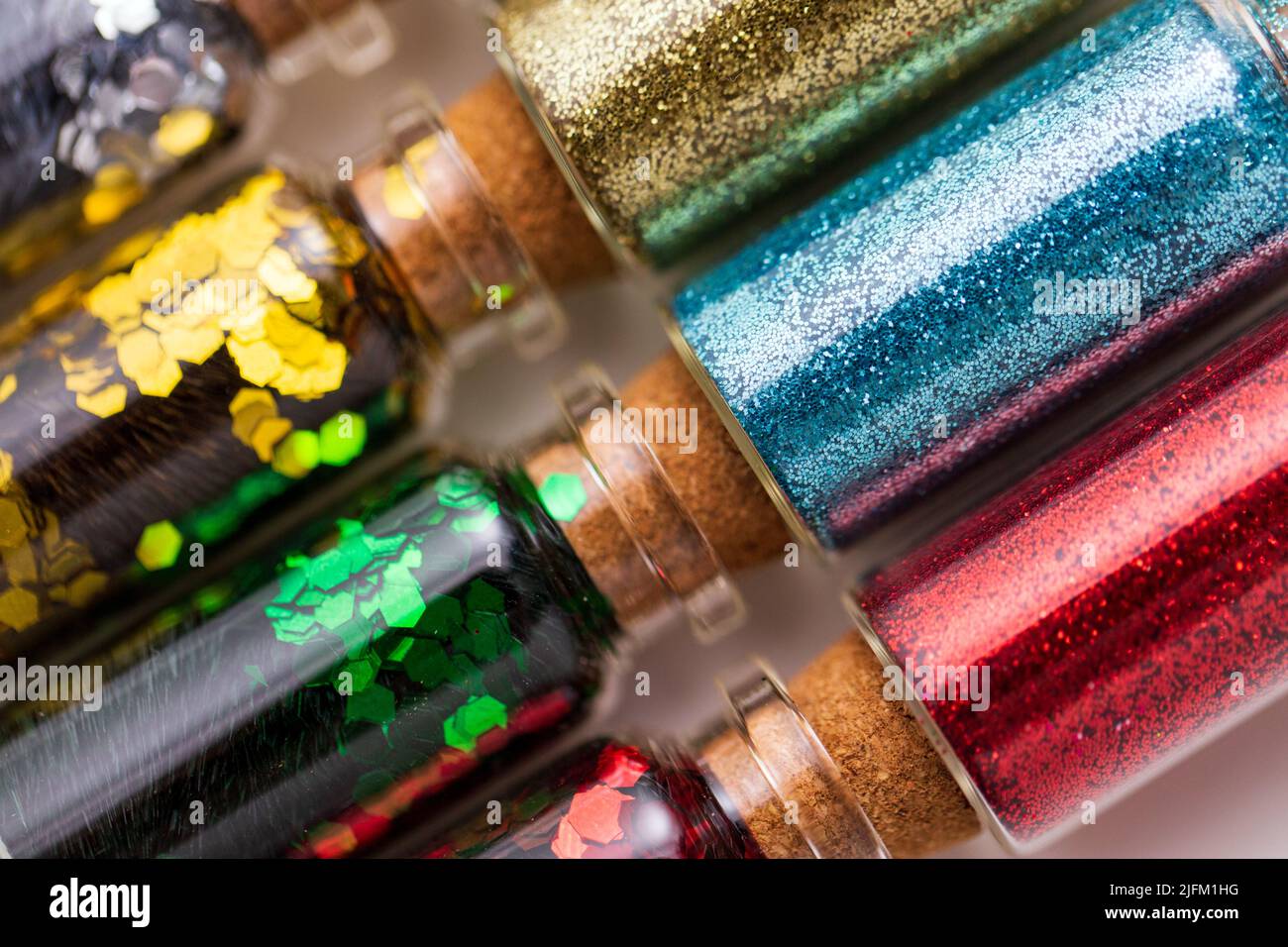 set of different glitters in small glass bottles Stock Photo - Alamy