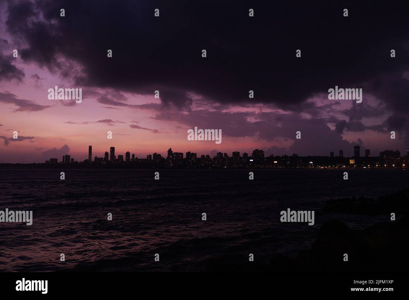 sunset of marine drive with pink and red sky, Mumbai Stock Photo - Alamy