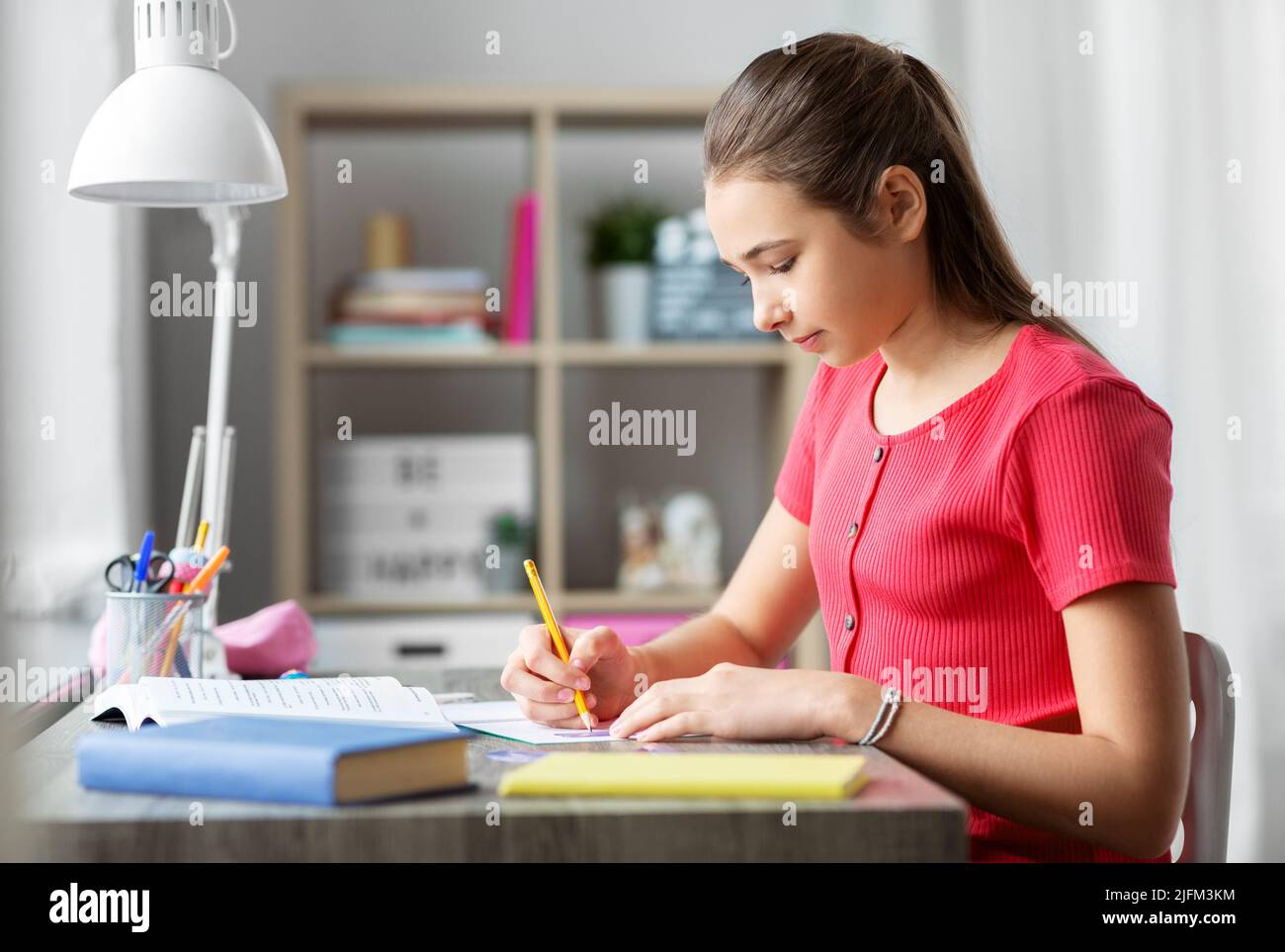 student girl with ruler drawing line in notebook Stock Photo - Alamy