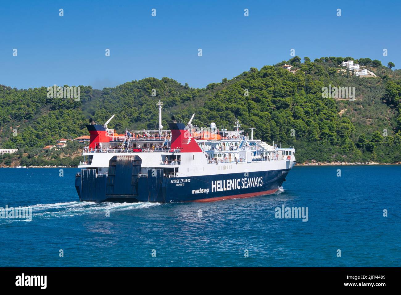 the Skiathos express ferry departs full of passengers from the port of ...