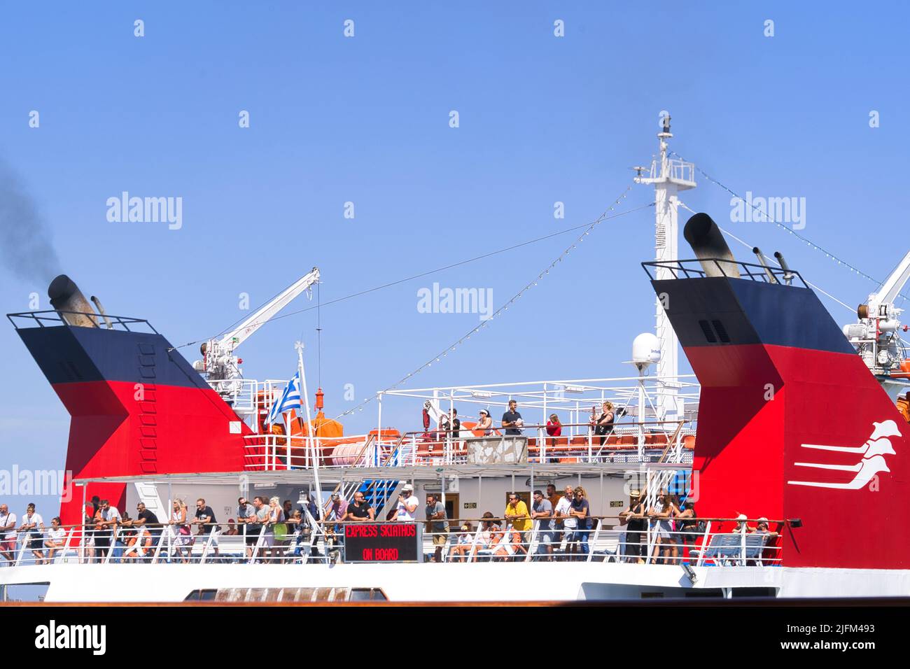 the Skiathos express ferry departs full of passengers from the port of ...