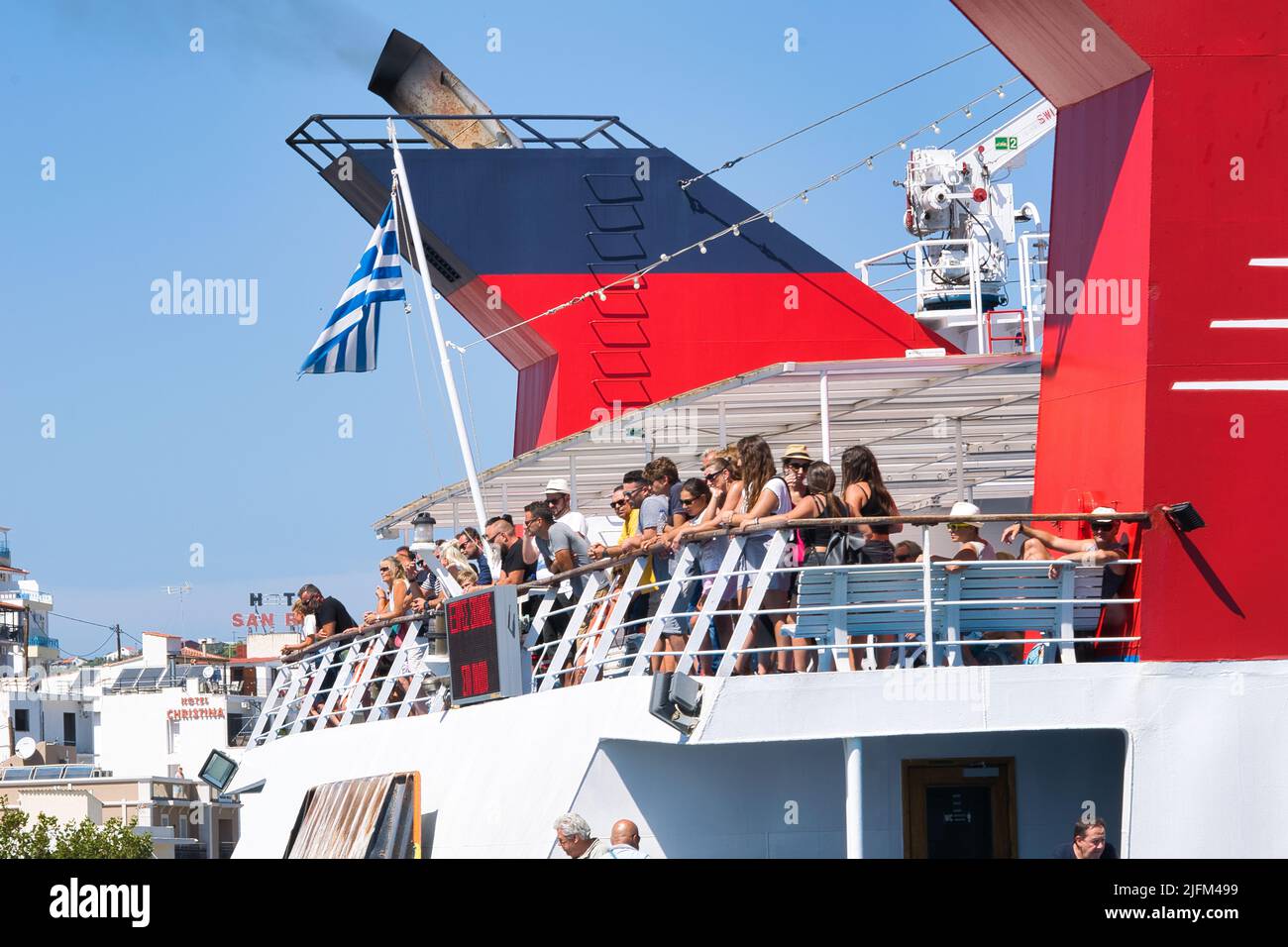 the Skiathos express ferry departs full of passengers from the port of ...