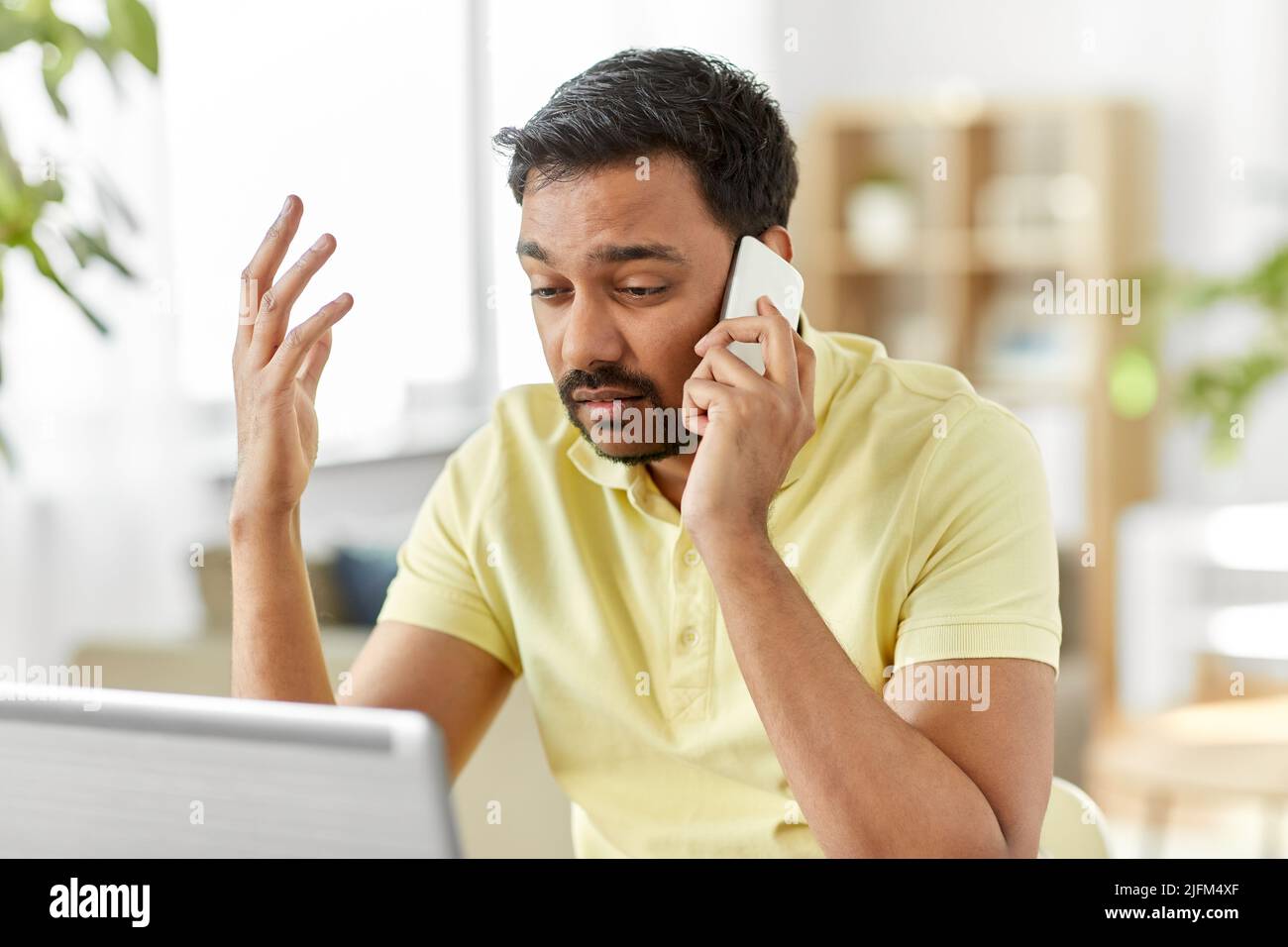 man calling on smartphone at home office Stock Photo - Alamy