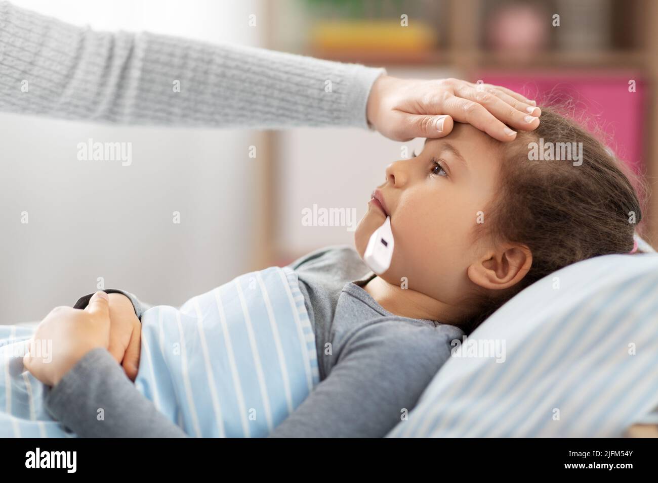 mother and sick daughter measuring temperature Stock Photo - Alamy