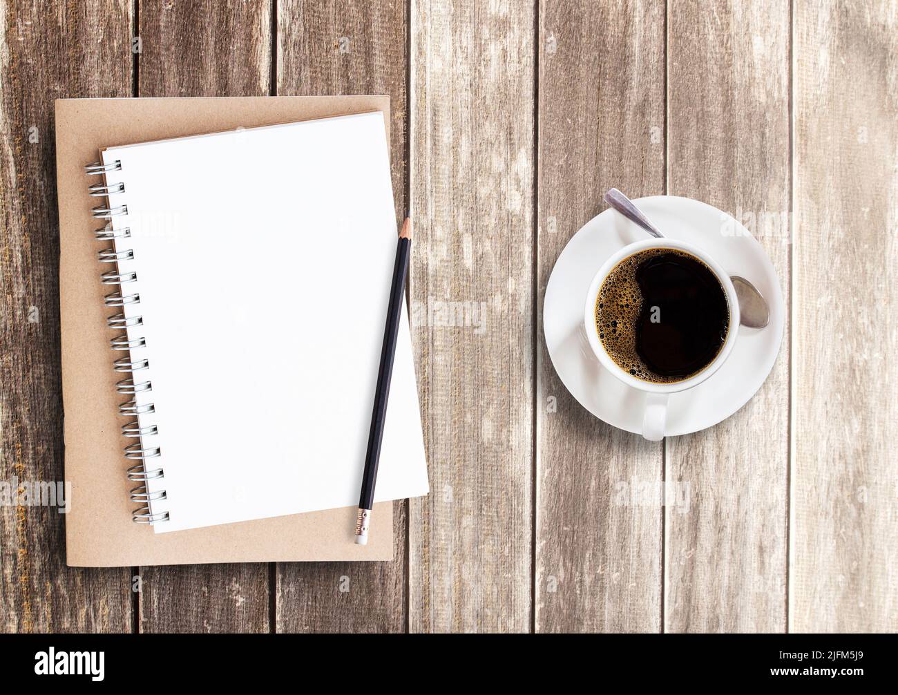Office desk table with notebook, cup of coffee and pencil on top view ...