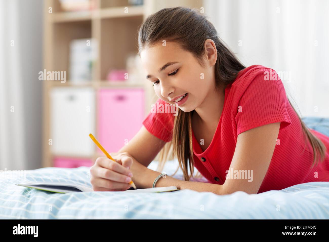 Teenage girl writing hi-res stock photography and images - Alamy