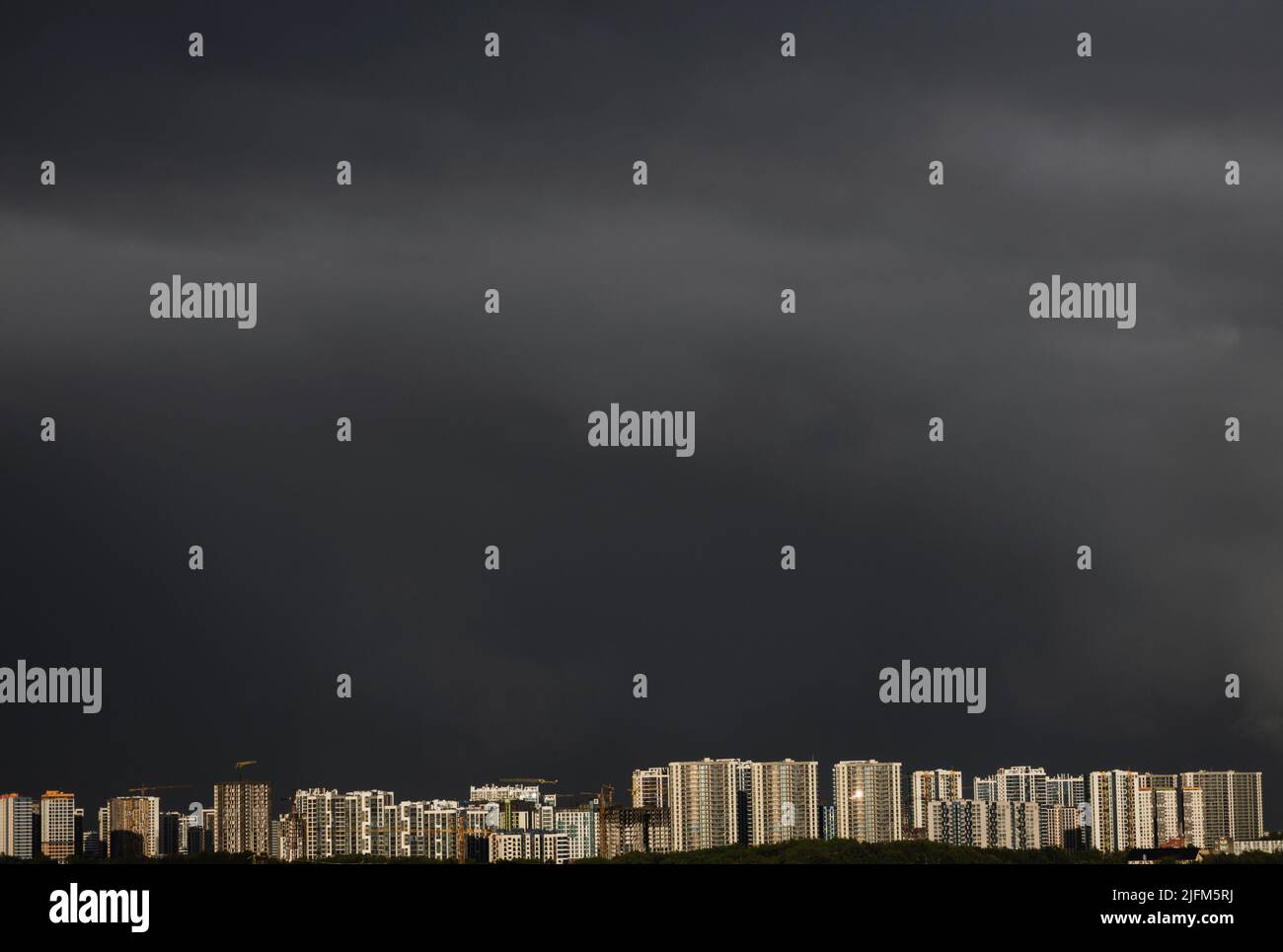 Dramatic stormy clouds over row of residential buildings. climate ...
