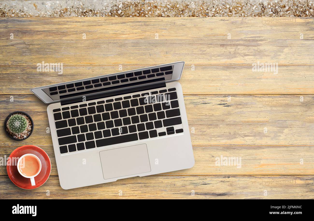 Office desk with laptop computer and coffee cup on wooden. top view ...