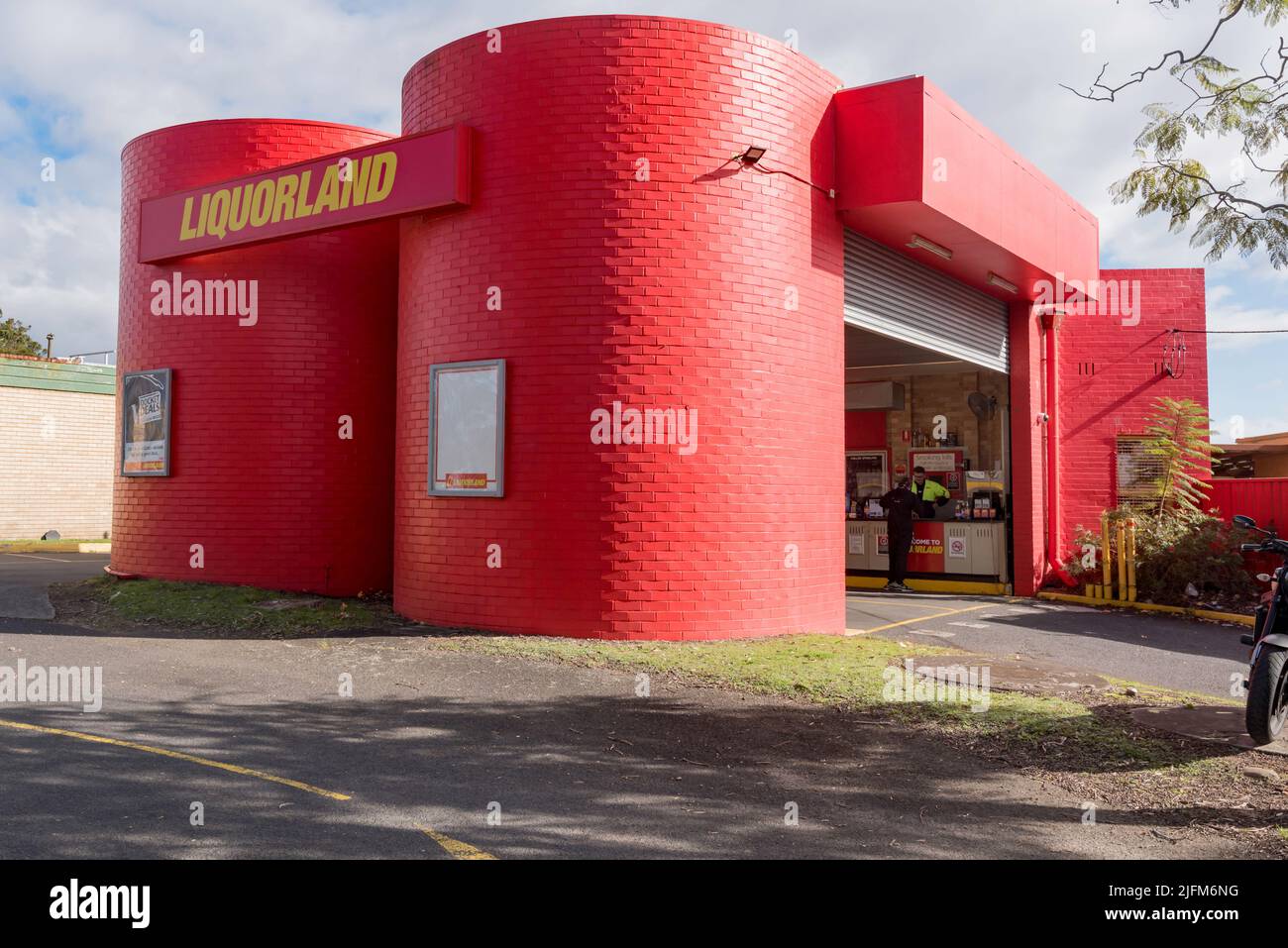 A bright red painted brick, post modern designed building that ...