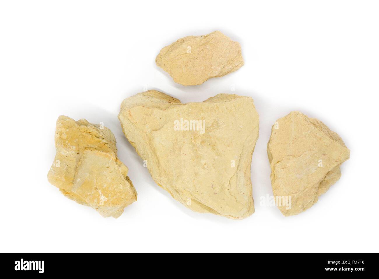 Yellow cosmetic clay in pieces Stock Photo - Alamy