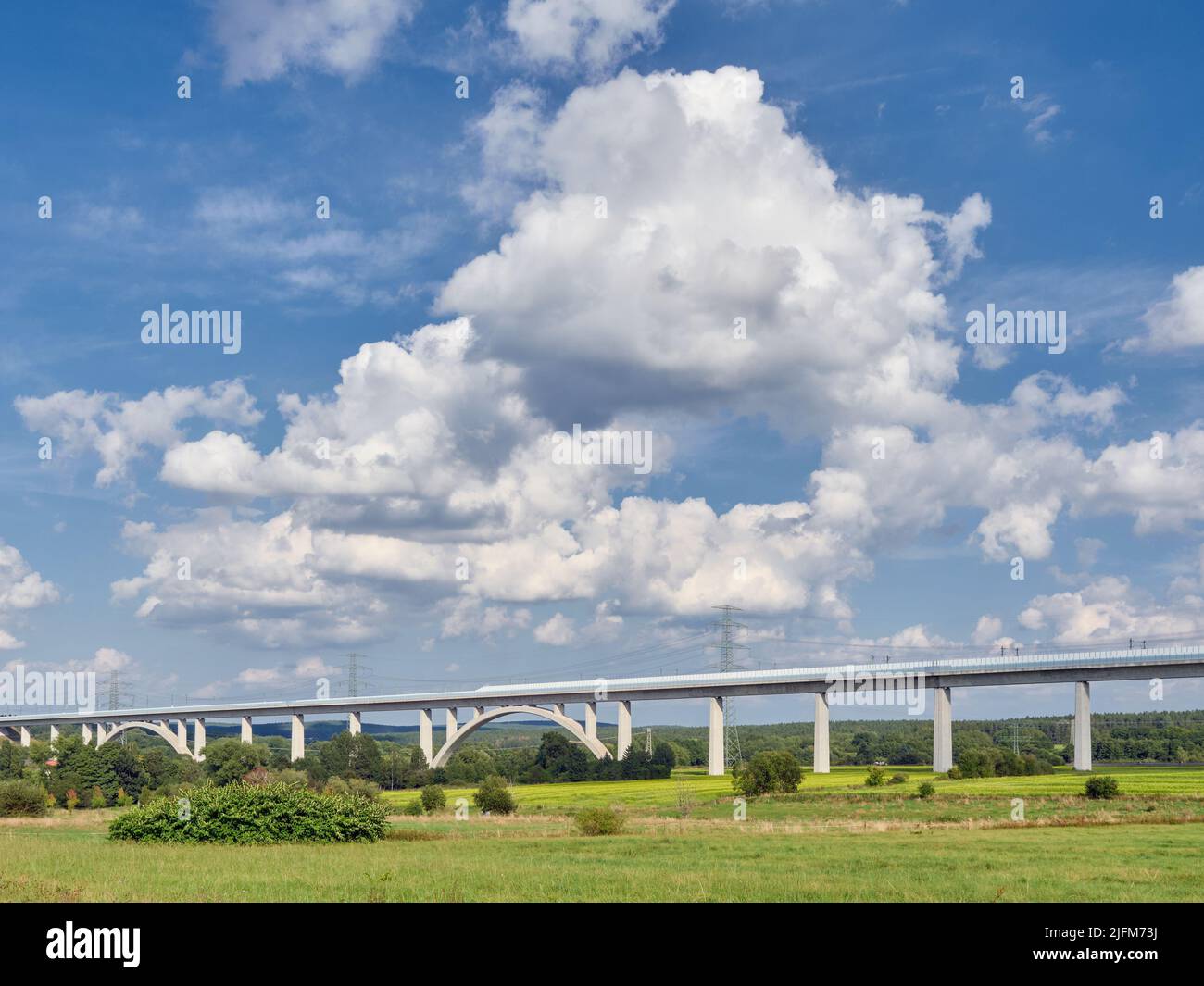 modern arch train bridge among meadows under an interesting sky Stock ...