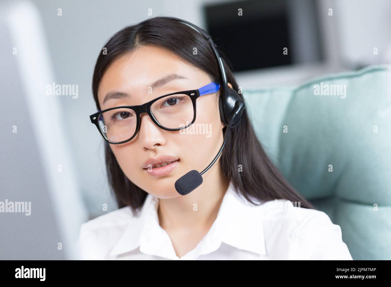 Close-up portrait photo of Asian female call center worker and tech ...
