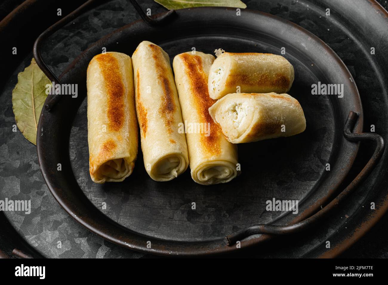 Georgian crepes stuffed on black dark stone table background Stock ...